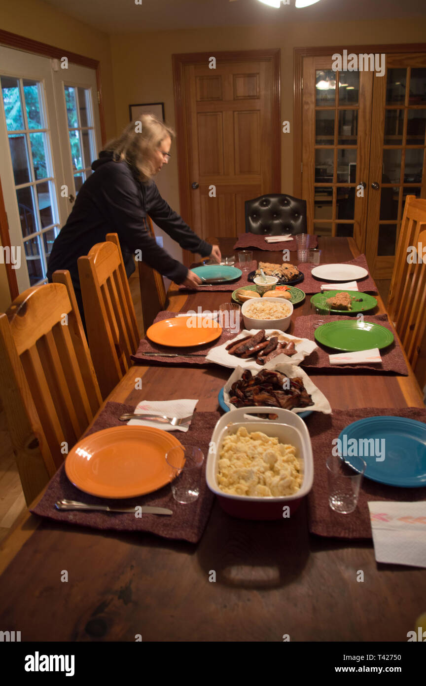 Woman setting up a Thanksgiving dinner for her family Stock Photo - Alamy