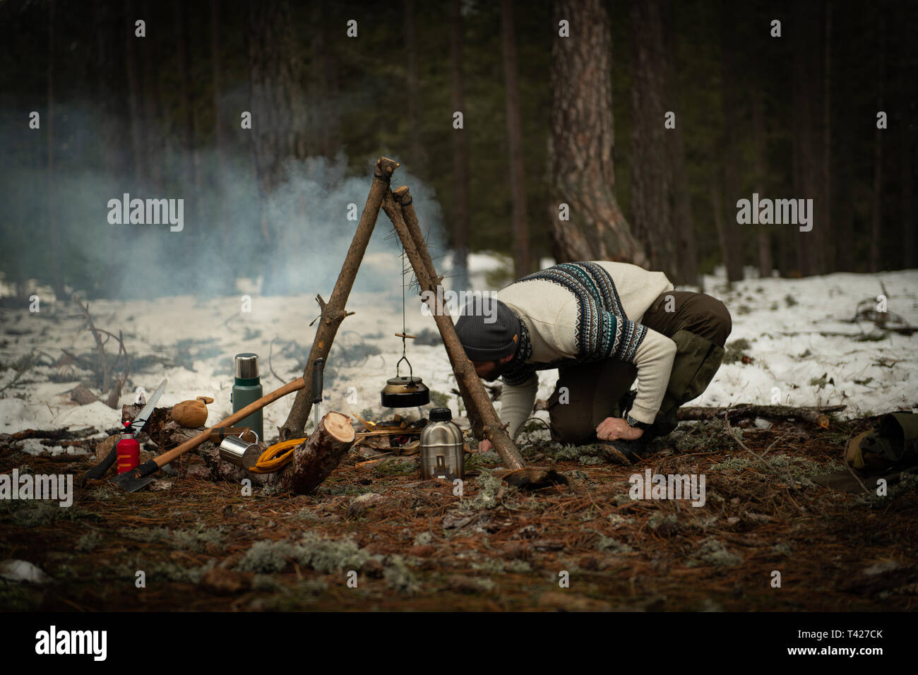 Man on a camping ground, making a fire Stock Photo - Alamy