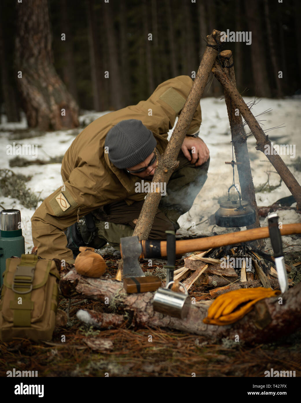 Man on a camping ground, making a fire Stock Photo - Alamy