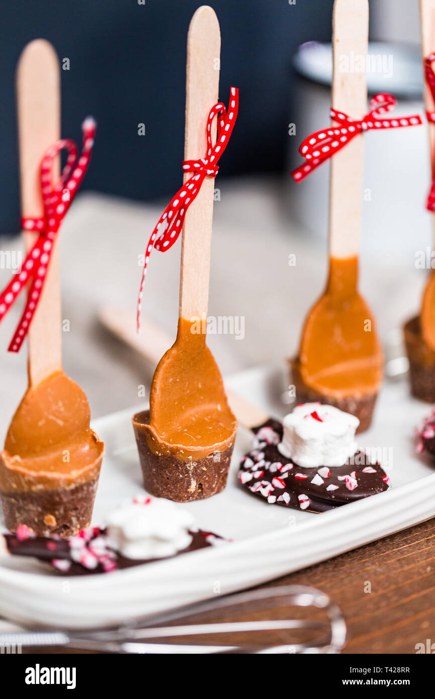 Salted caramel hot cocoa spoons on a white tray Stock Photo - Alamy