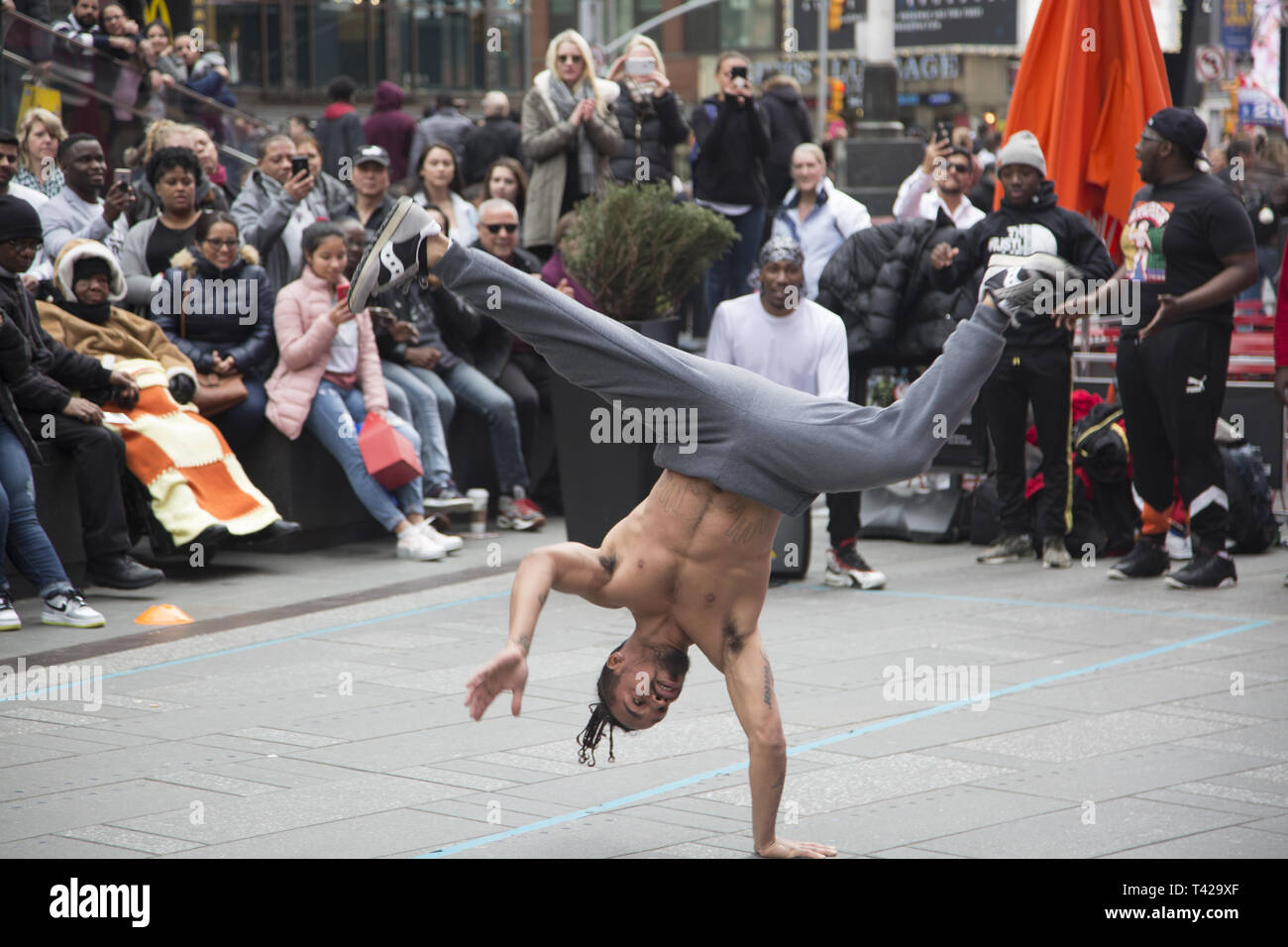 Crowds are entertained in Times Square by a troupe of talented ...