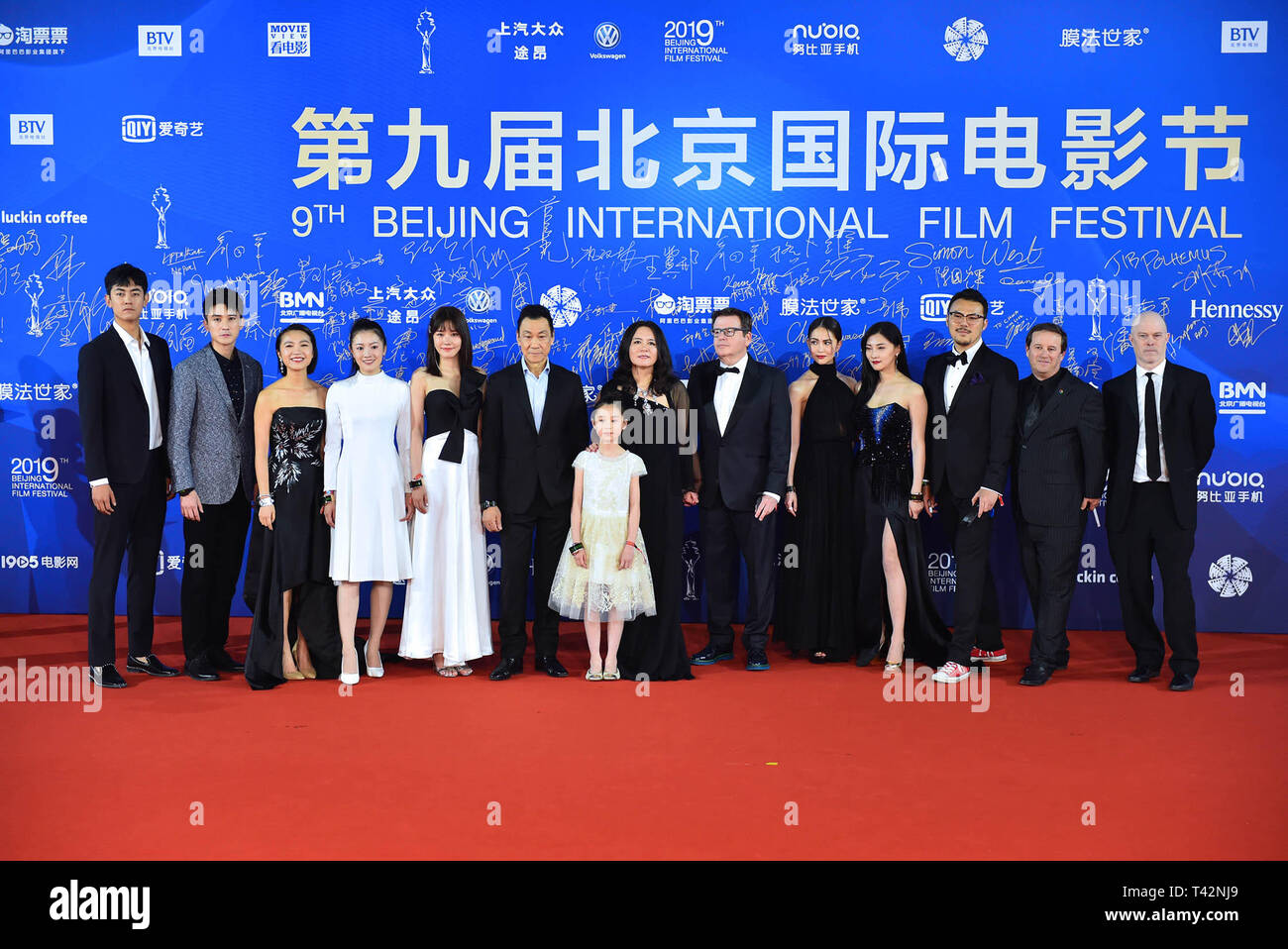 Beijing, China. 13th Apr, 2019. Cast members of the film "SkyFire" pose ...