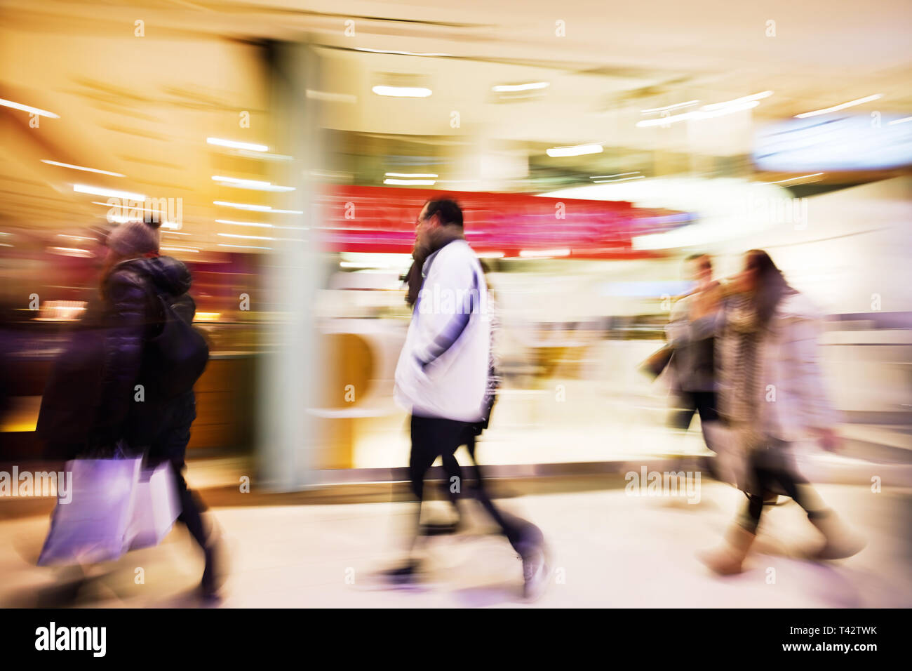A shopper walking against shop window Stock Photo - Alamy