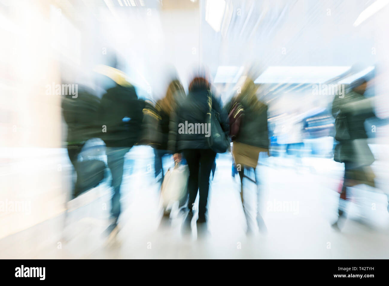 Crowd of people rushing through corridor, zoom effect, motion blur ...