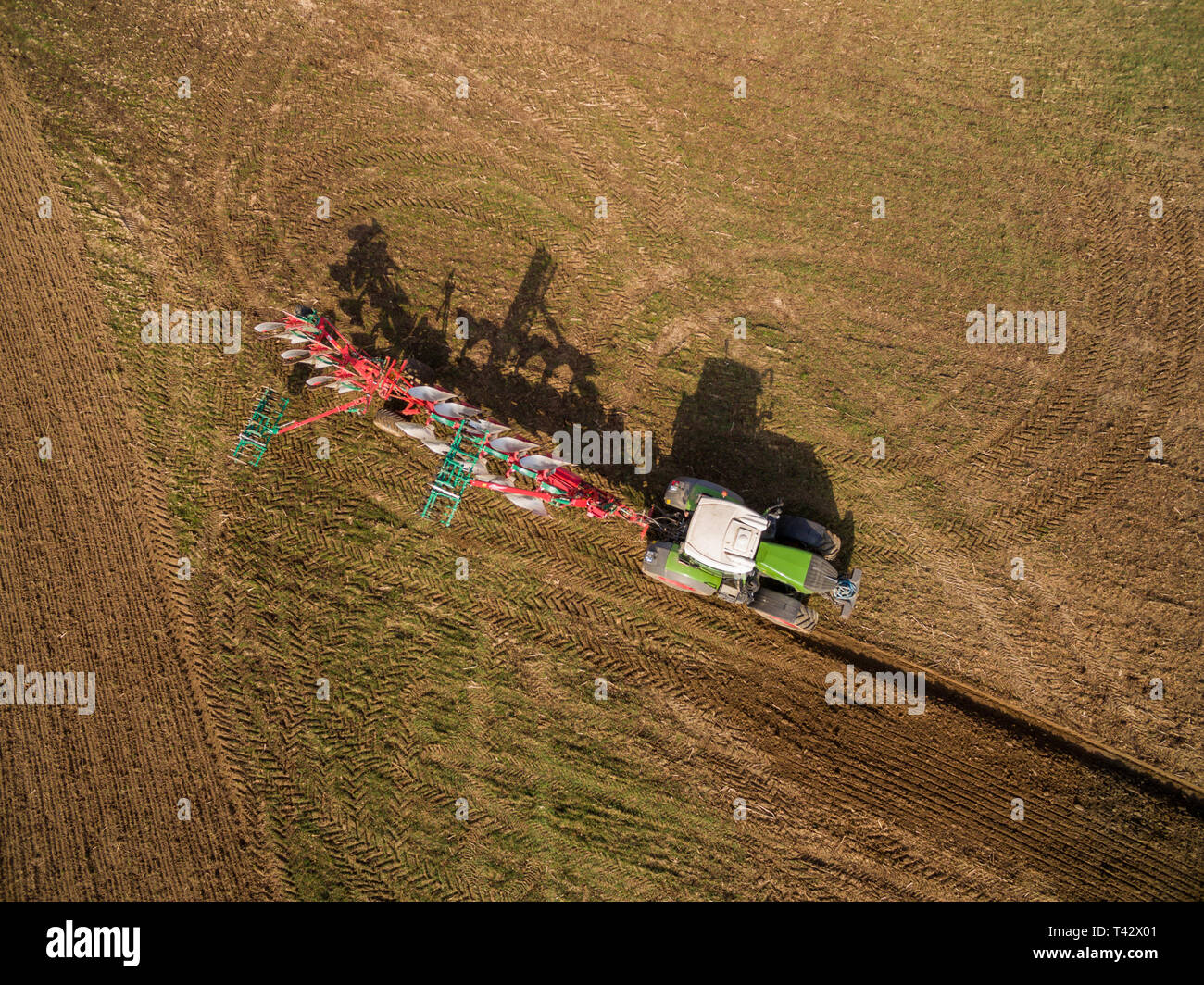 aerial view of modern tractor working on the agricultural field ...
