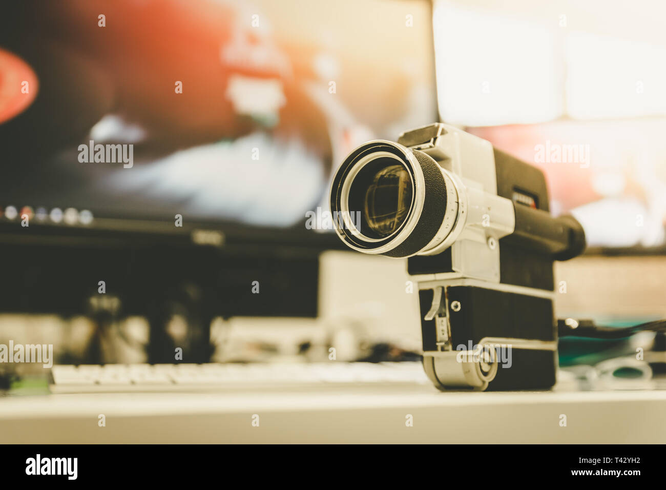 Vintage old movie camera, computer for cutting in the blurry background ...