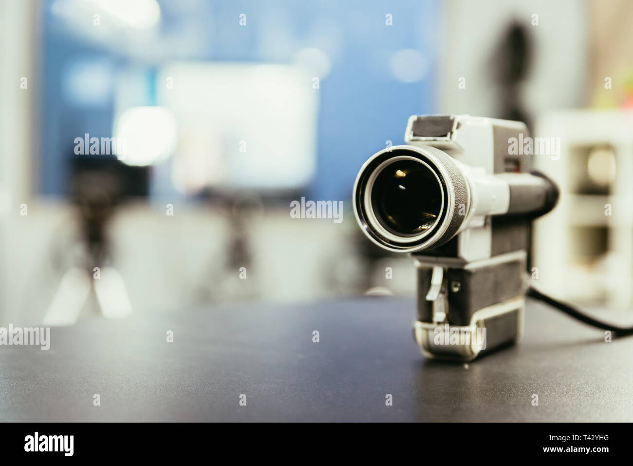 Vintage old movie camera, production studio in the blurry background ...