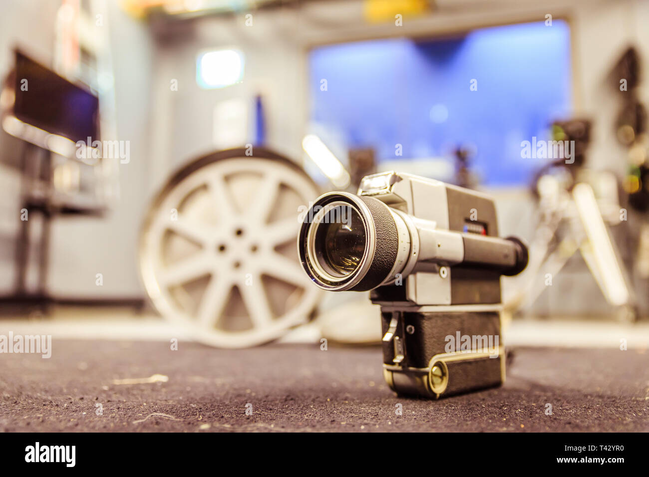 Vintage old movie camera, production studio in the blurry background ...