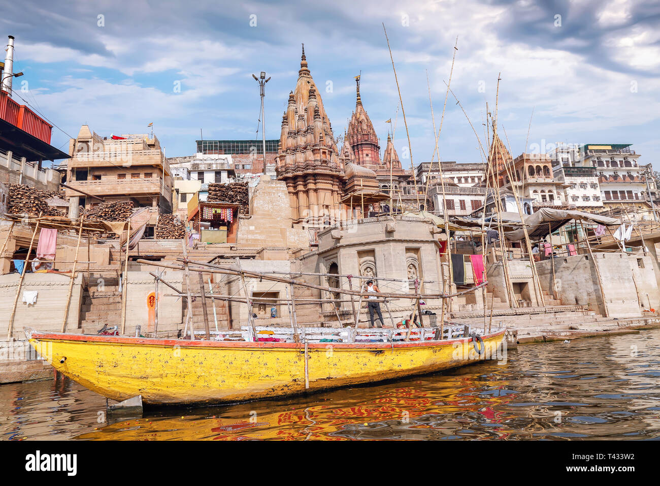 Ancient Varanasi city architecture with wooden boat near the Ganges ...