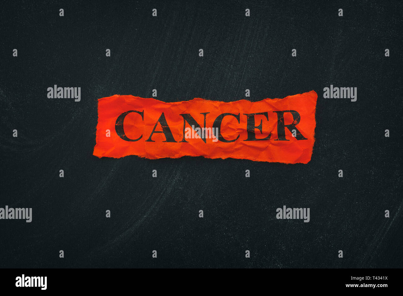 Word Cancer on red torn piece of paper. Close up Stock Photo - Alamy