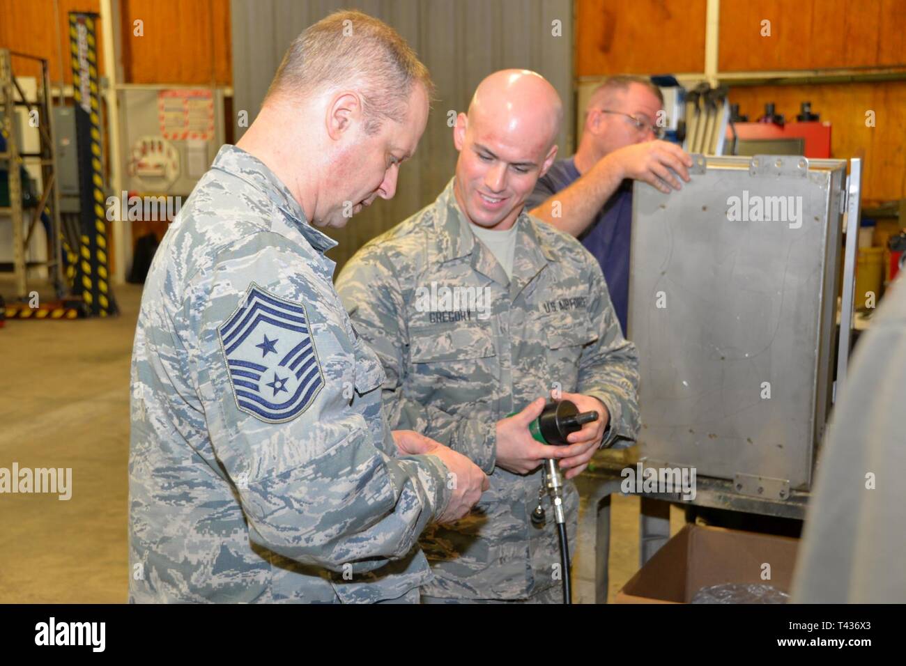 U.S. Air Force Airman Alexander Gregory (center), shows the Command ...