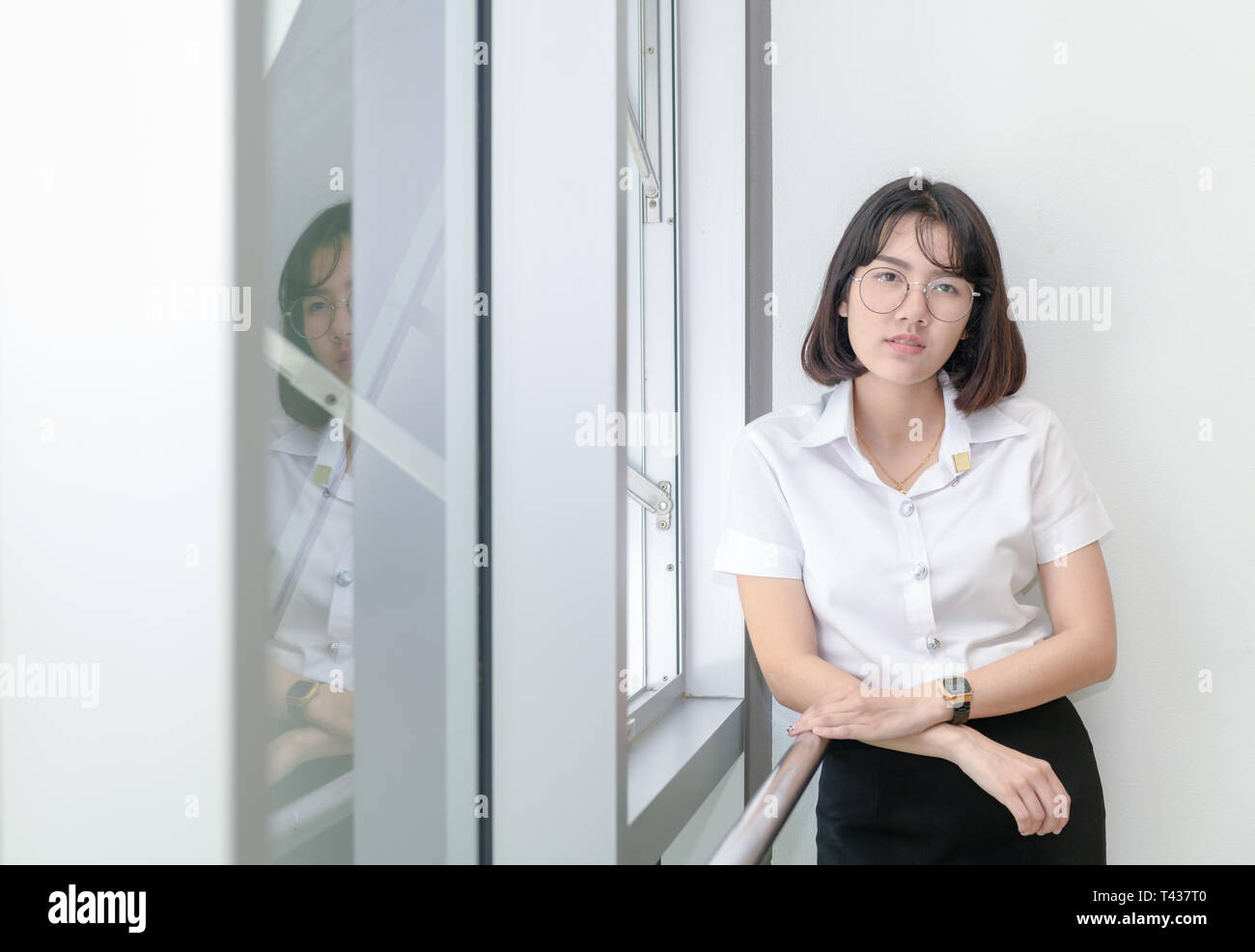 Smart girl students in uniform stand near window, Education concept ...