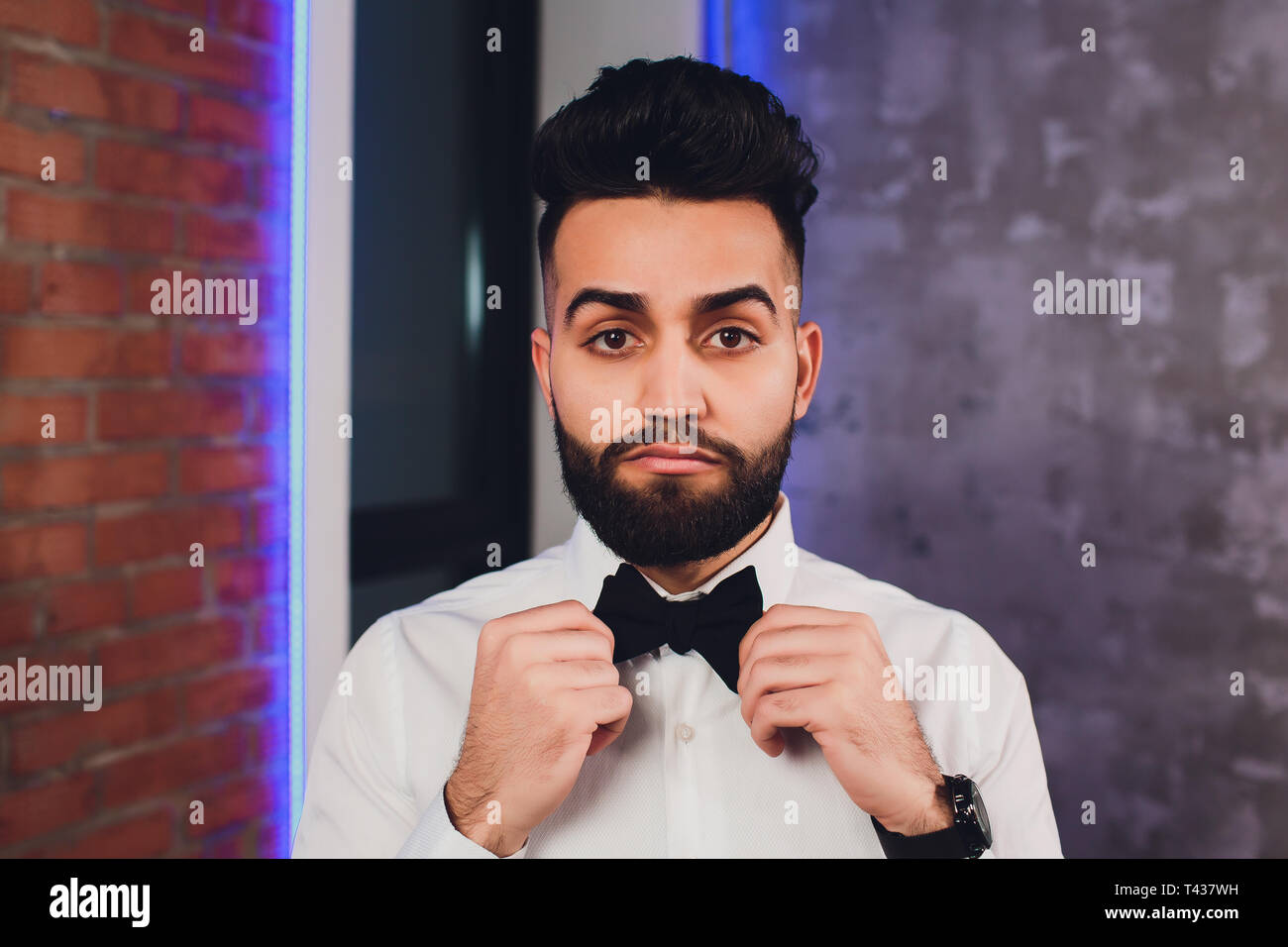 Male customer at shopping mall trying business clothes, shop assistant ...