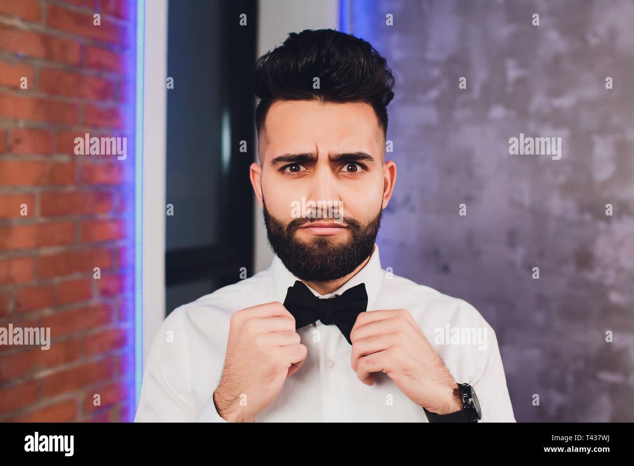 Male customer at shopping mall trying business clothes, shop assistant ...