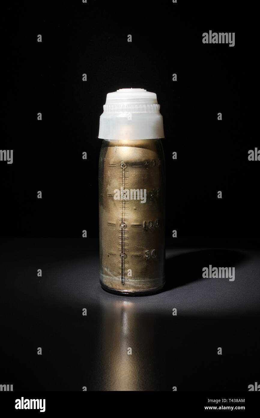 Old soviet glass bottle with measuring scale with bronze powder patina ...