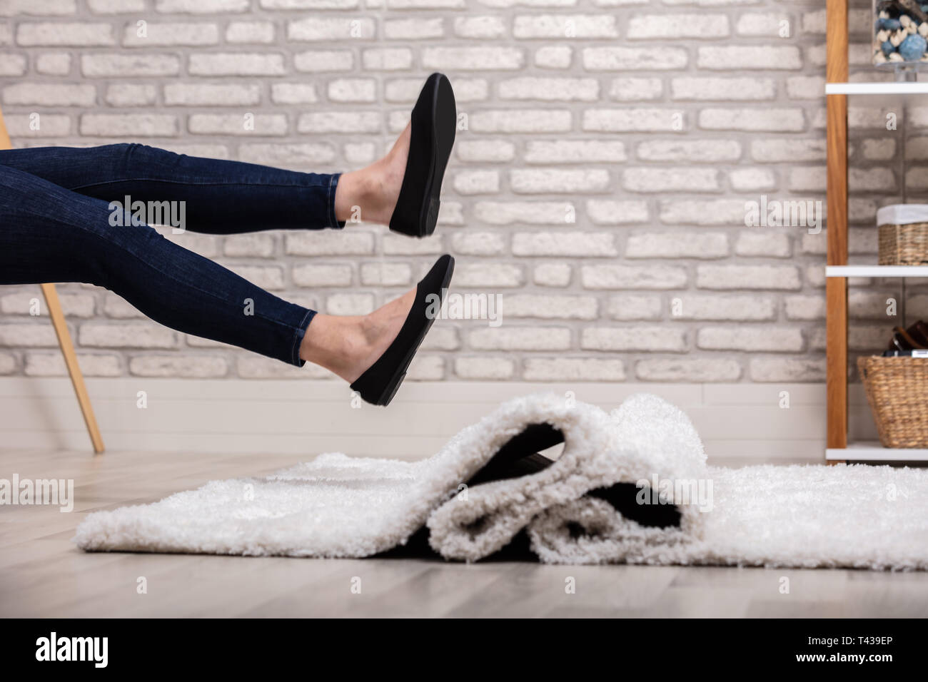 Low Section Of Woman Legs Stumbling With A Carpet At Home Stock Photo ...