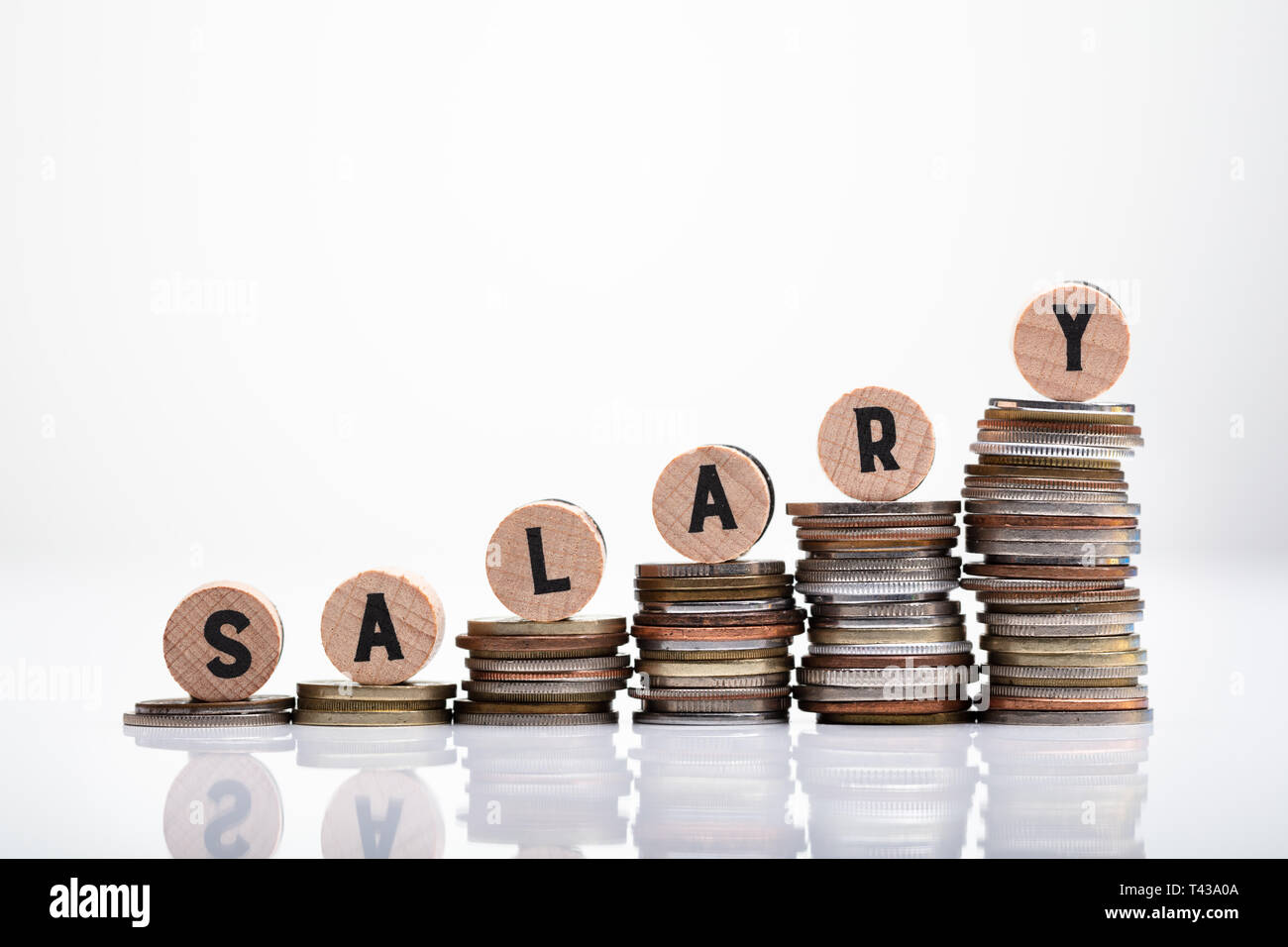 Salary Wooden Block Text Over Increasing Stack Of Coins Over There ...