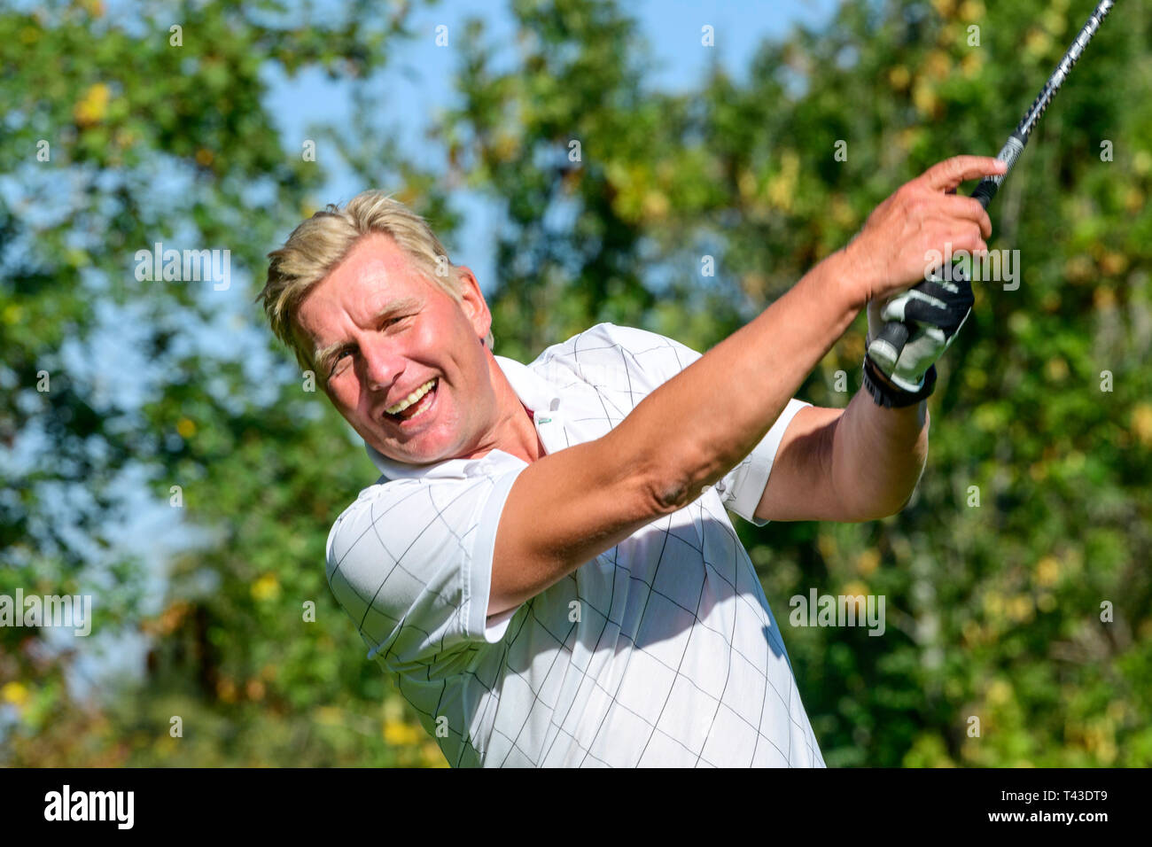 Man having fun while playing golf Stock Photo - Alamy