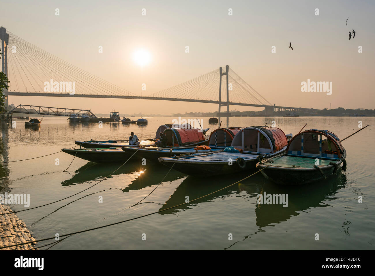 Horizontal view of small boats moored on the Hooghly river in Kolkata ...