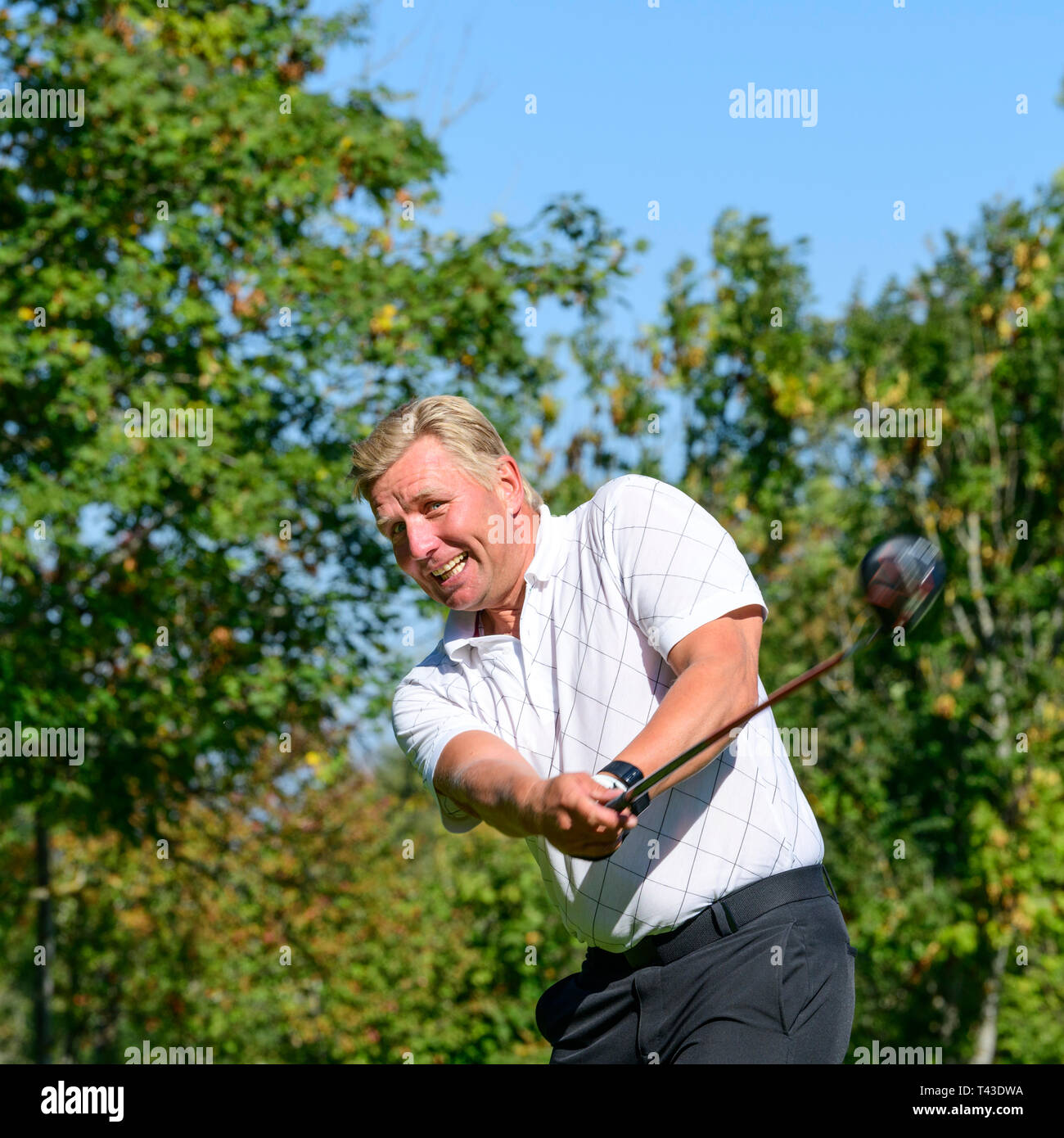 Man having fun while playing golf Stock Photo - Alamy