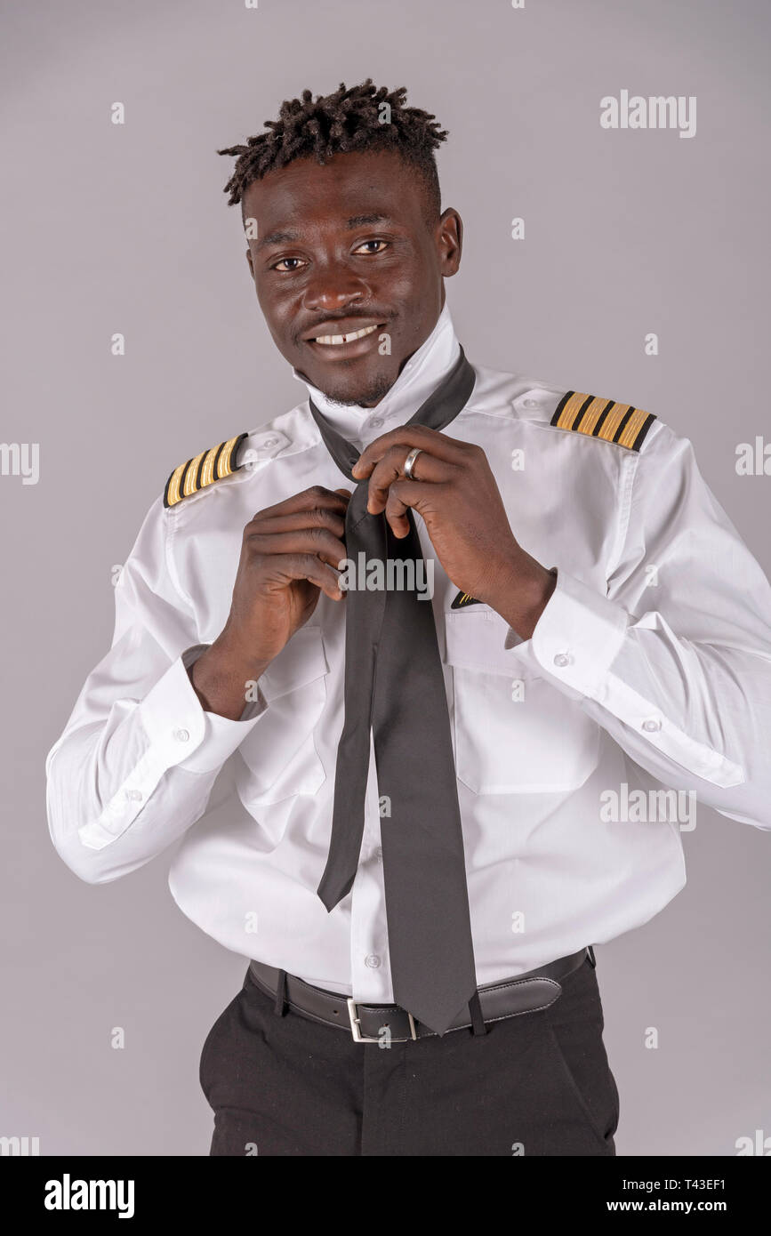London,UK. April 2019. A young airline pilot with an african dred ...