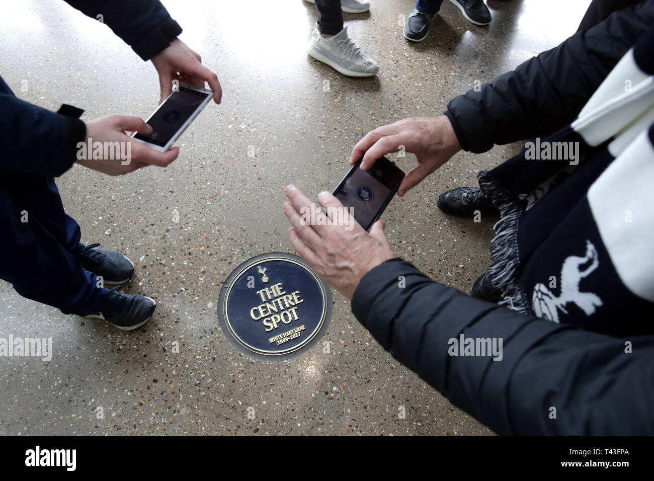 Fans take a photo of "The Centre Spot" plaque before the Premier League ...