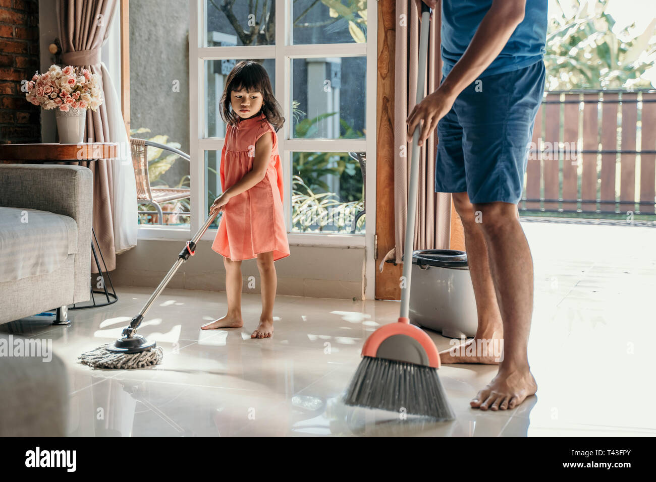 little girl help her daddy to do chores at home Stock Photo - Alamy