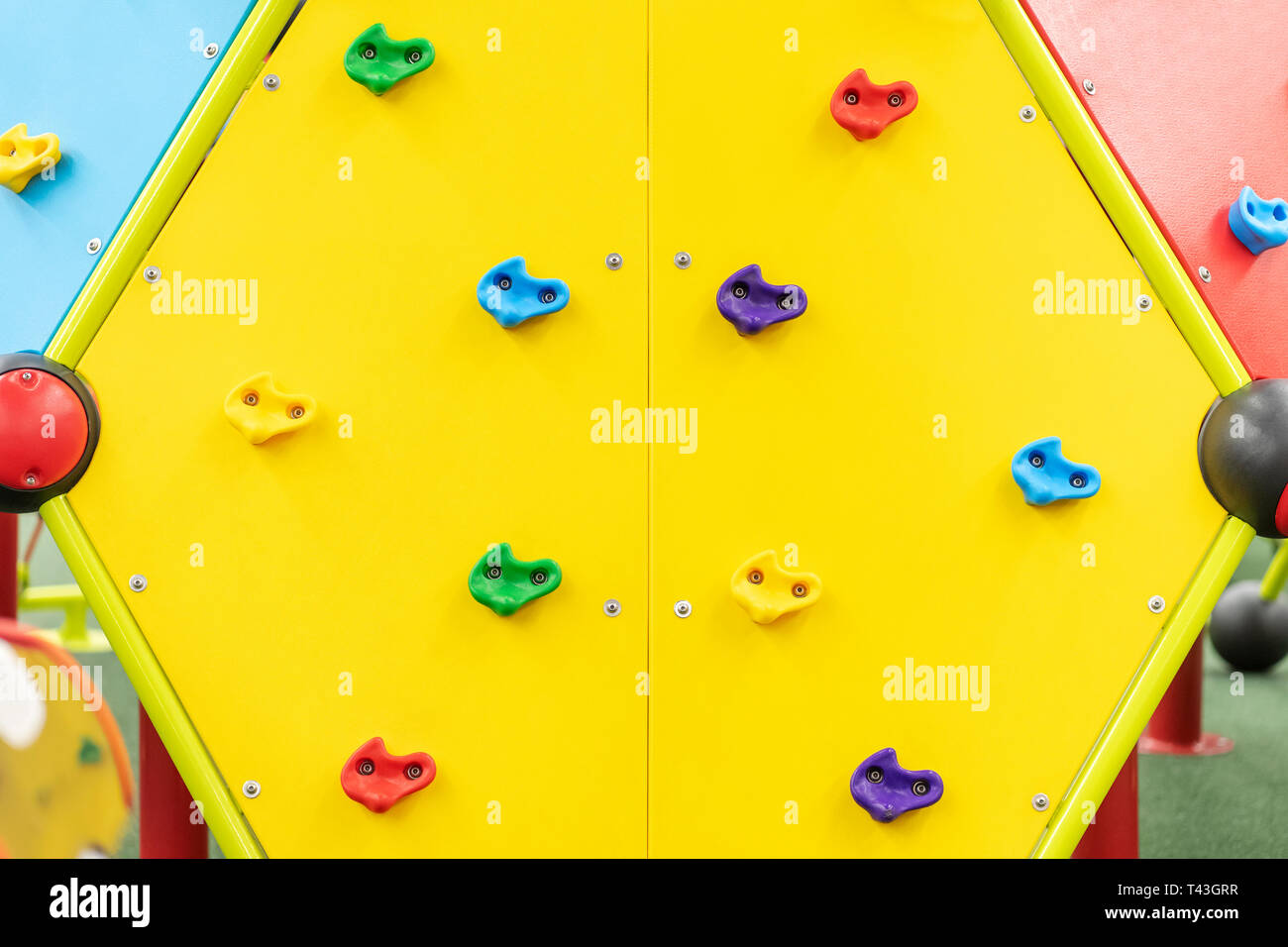 small yellow climbing wall for small children in the playground Stock ...