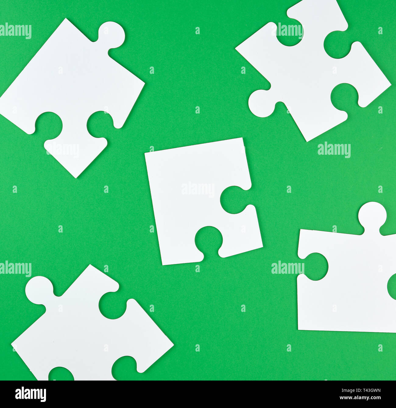white empty big puzzles on a green background. Concept in business ...