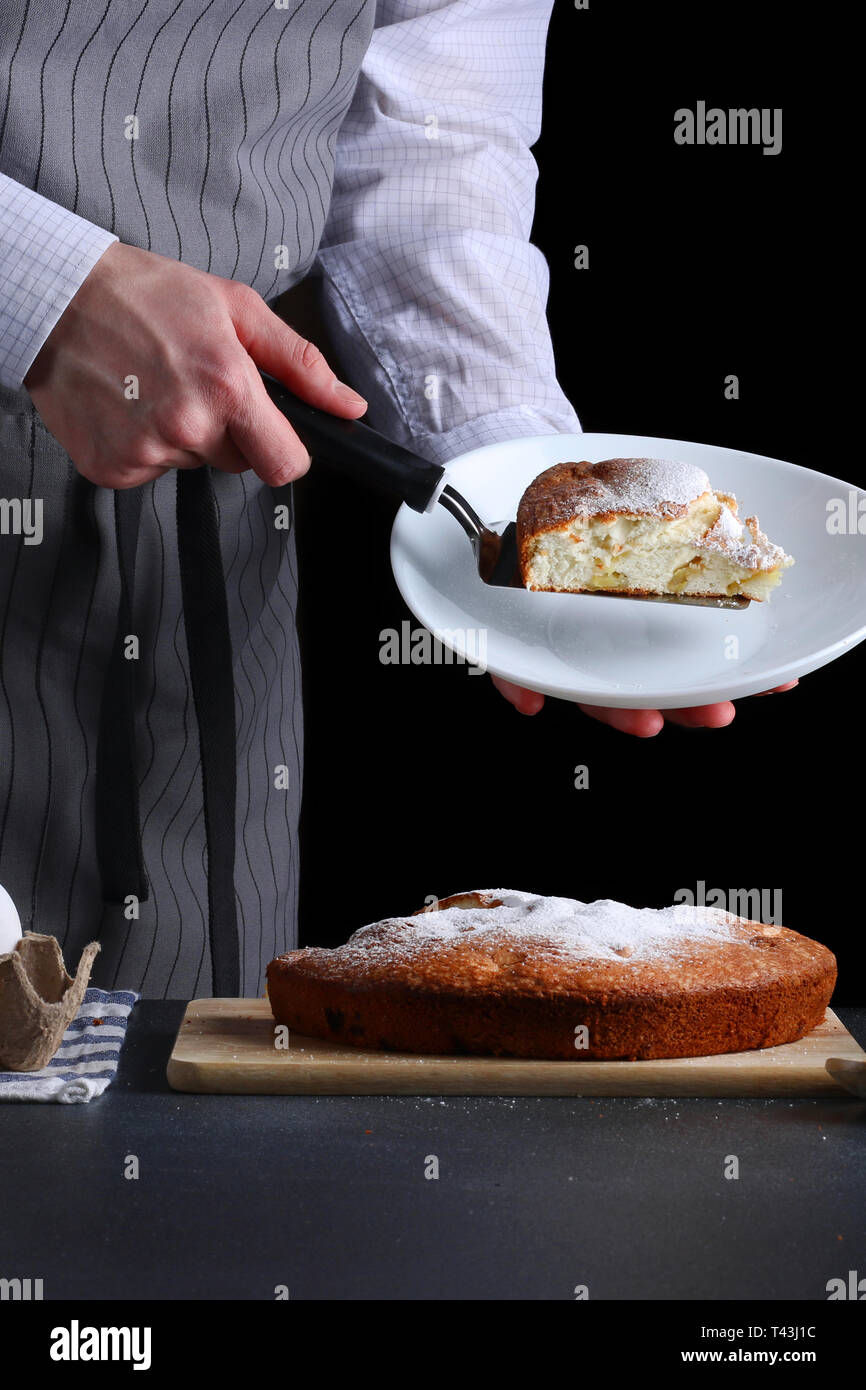 chef serves the pie on dark background. pie recipe concept Stock Photo ...