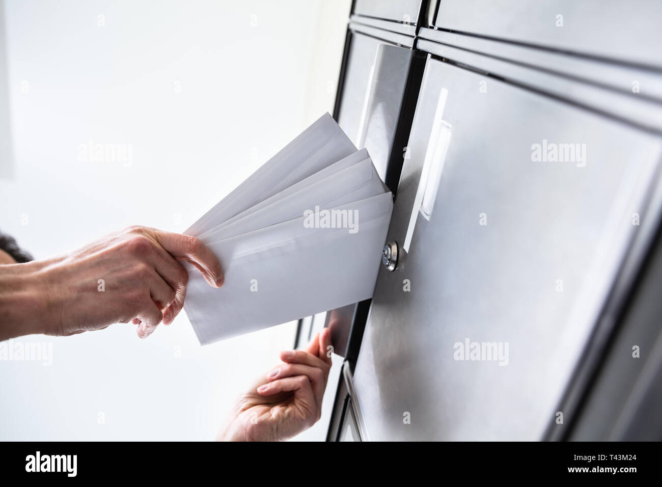 Low Angle View Of Person's Hand Inserting Envelopes In Mailbox Stock ...
