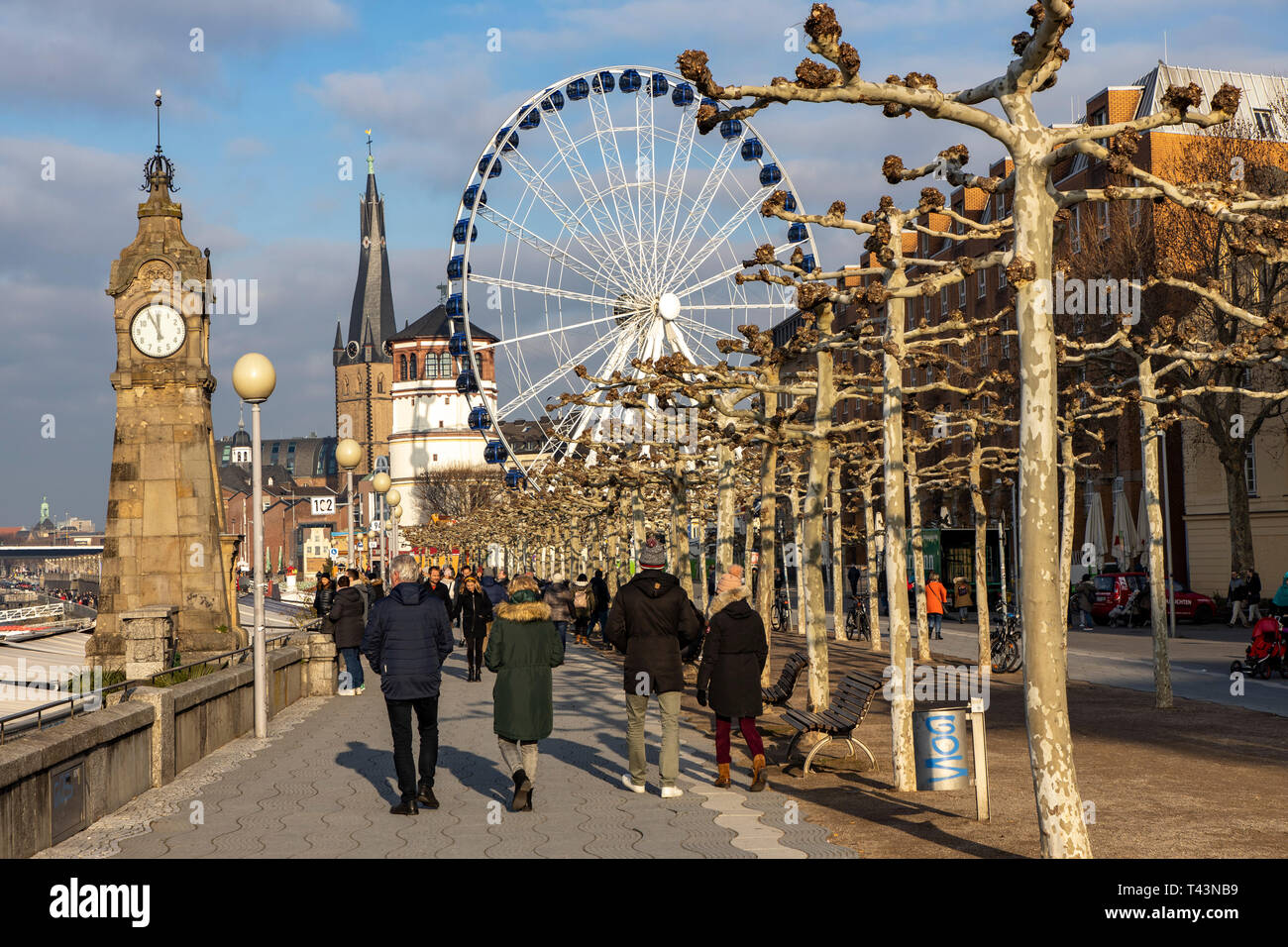 Rhine promenade in Dusseldorf, Ferris wheel, old castle tower, basilica ...