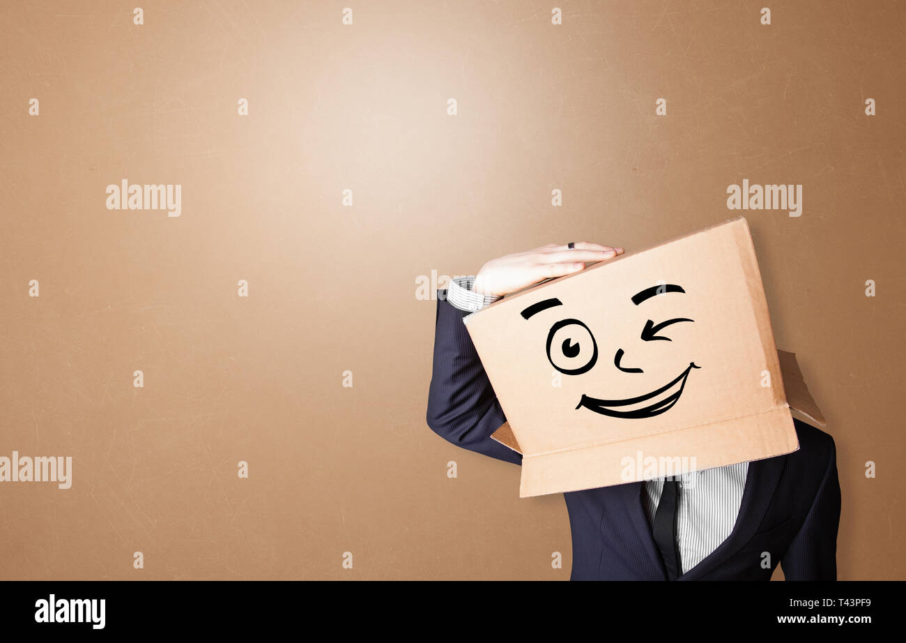 Handsome man standing and gesturing with a carton box on his head Stock ...