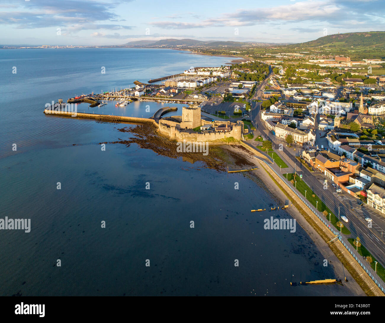 Belfast Lough. Medieval Norman Castle in Carrickfergus in sunrise light ...