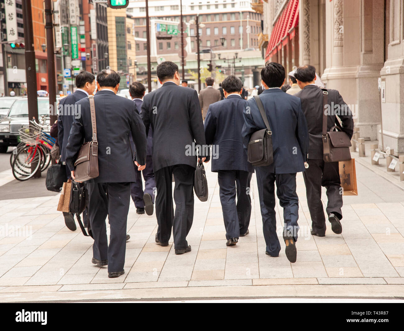 Group of salarymen walking together in the Nihombashi financial ...