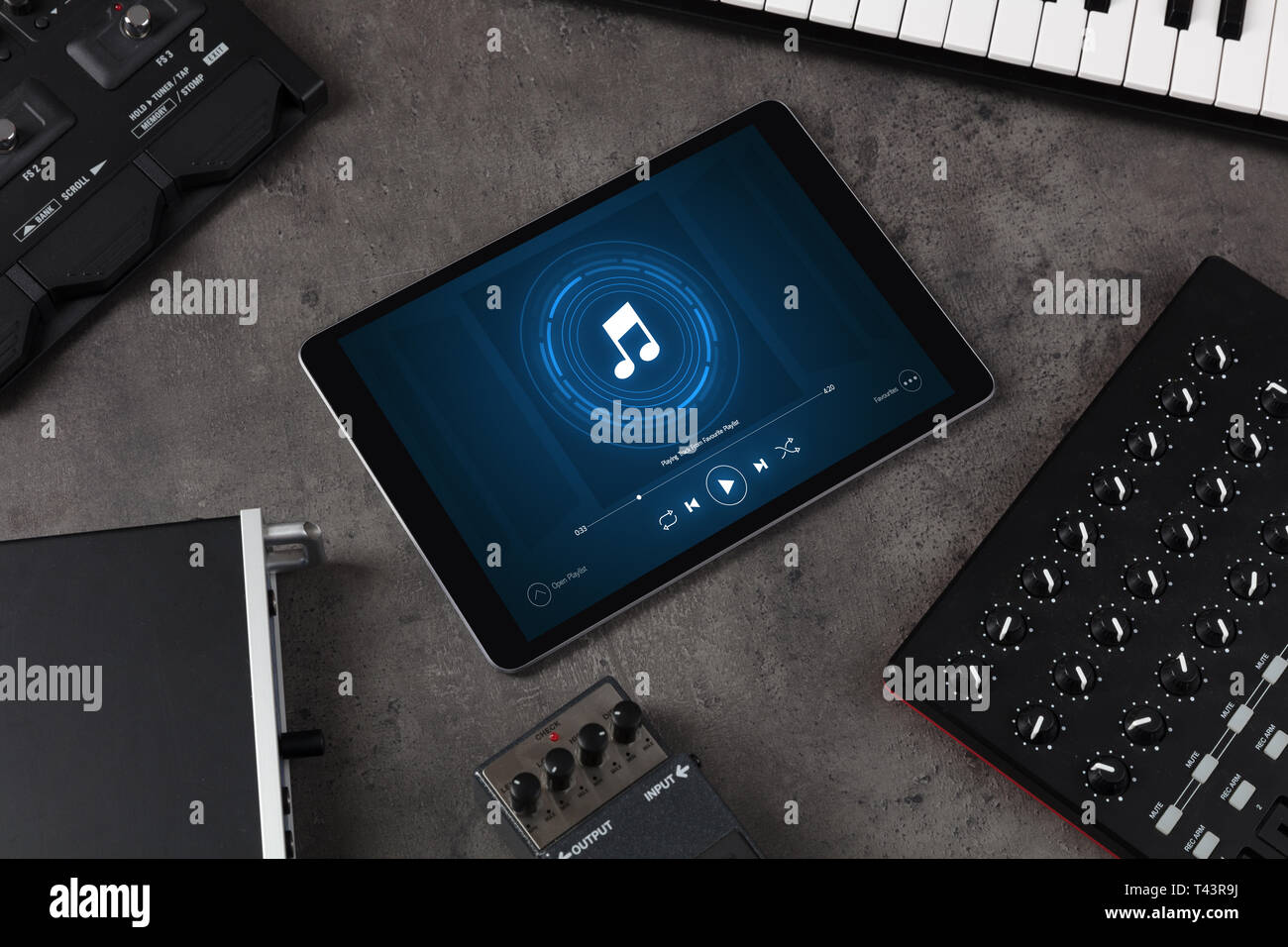 Playing song on tablet with electronic music instruments around Stock ...