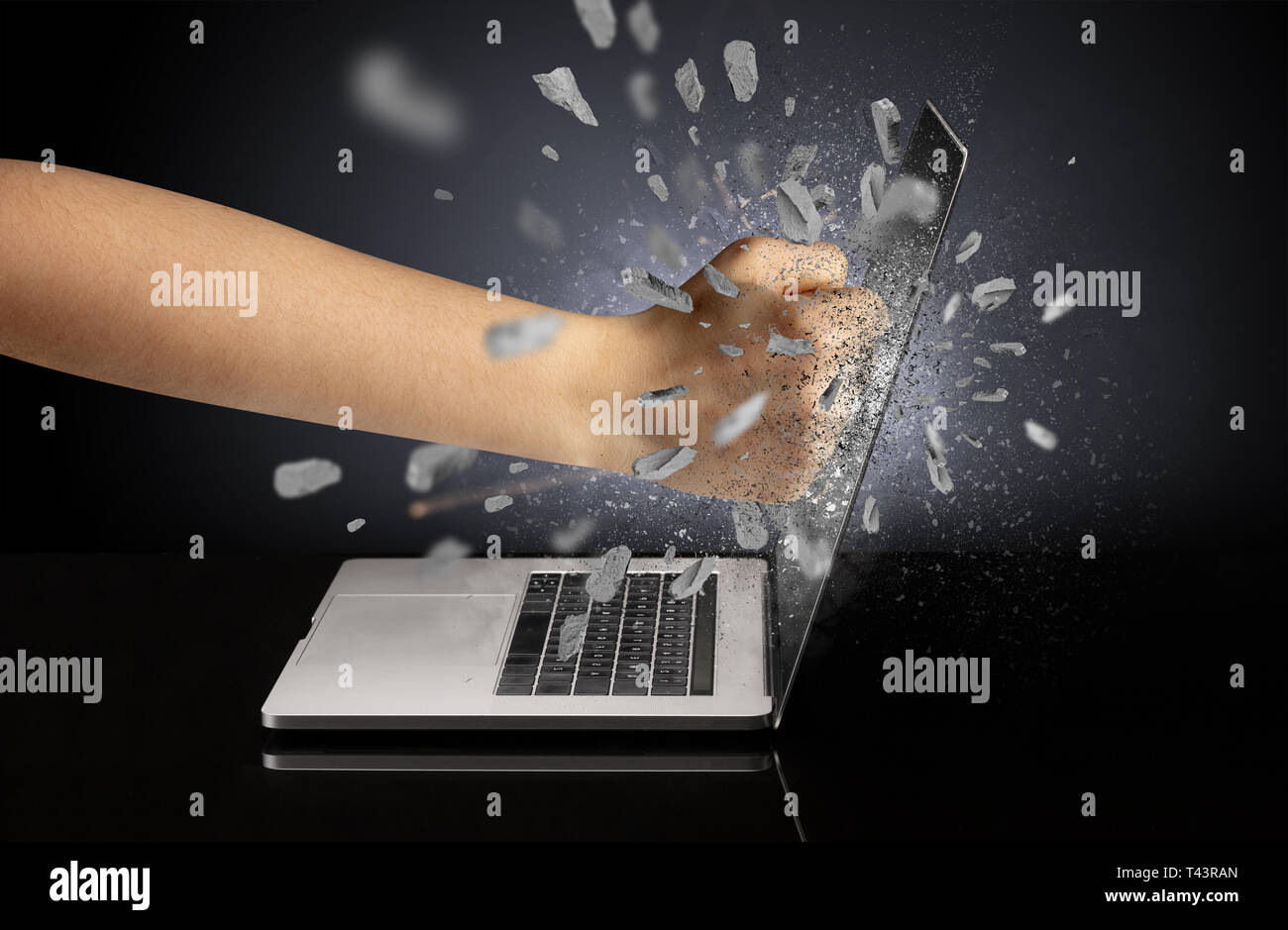 Strong male hand breaks laptop screen Stock Photo - Alamy