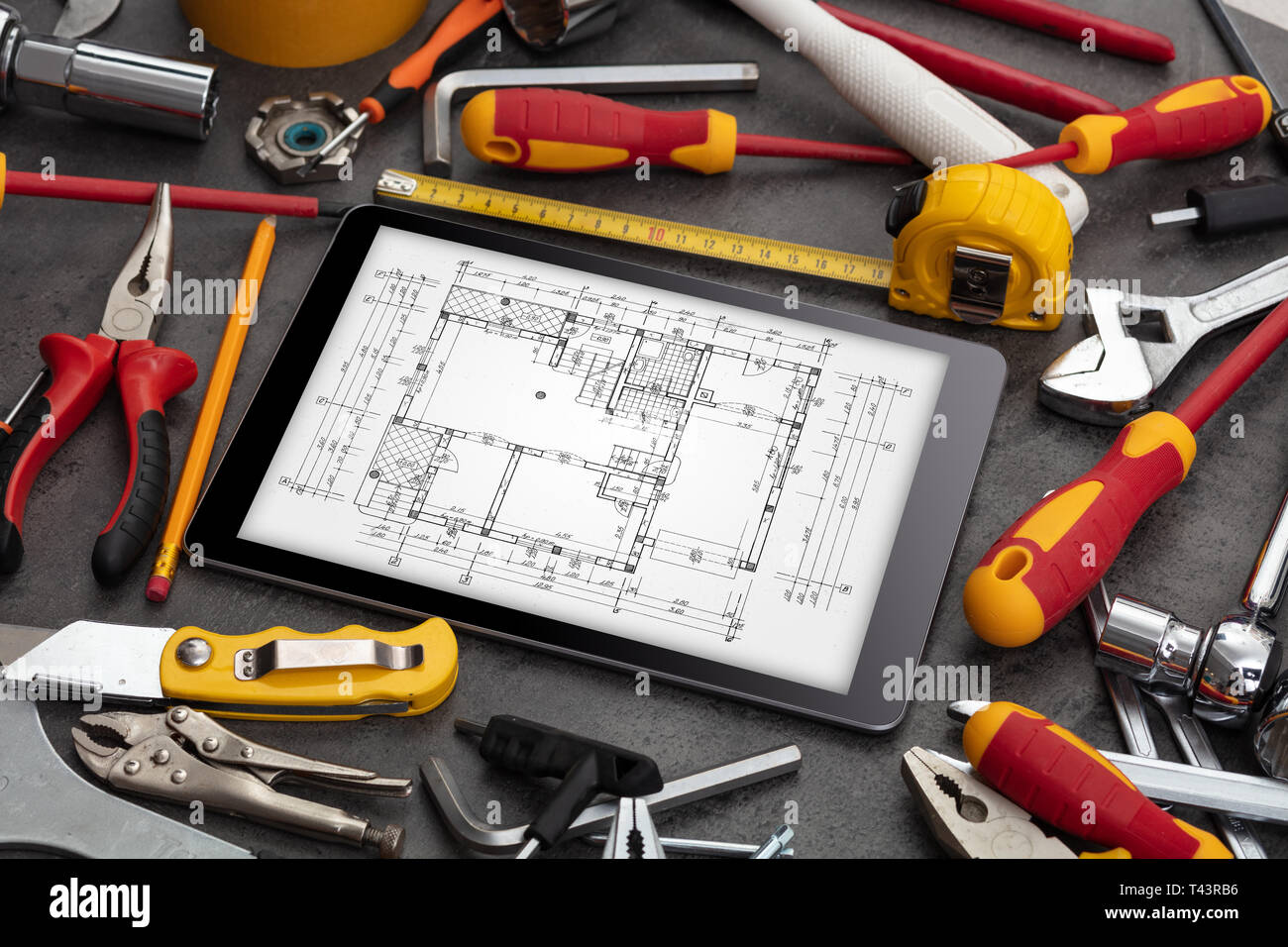 Tablet with construction tools and blueprint concept Stock Photo - Alamy
