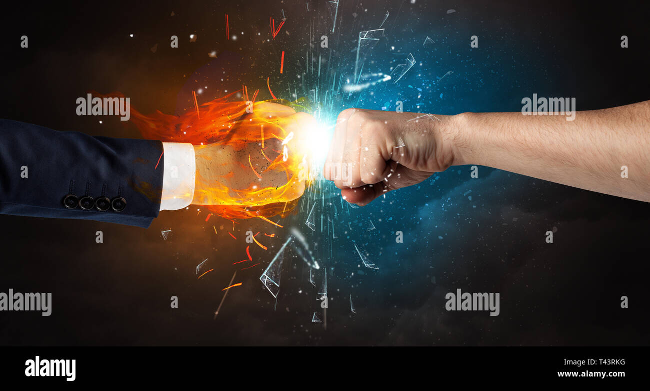 Two hands fighting and breaking glass into small pieces with fire and ...