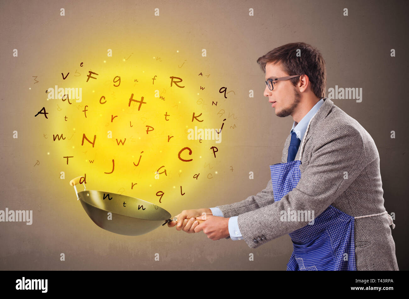 Young person cooking letters in wok Stock Photo - Alamy