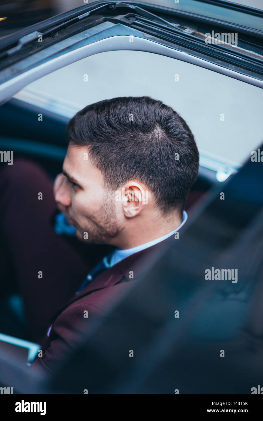 Above head perspective of a businessman working on his tablet while ...