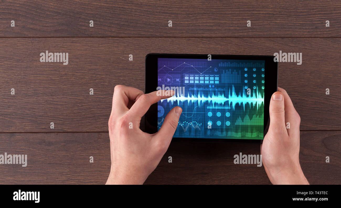 Hand touching tablet with waveforms and sound design concept Stock ...