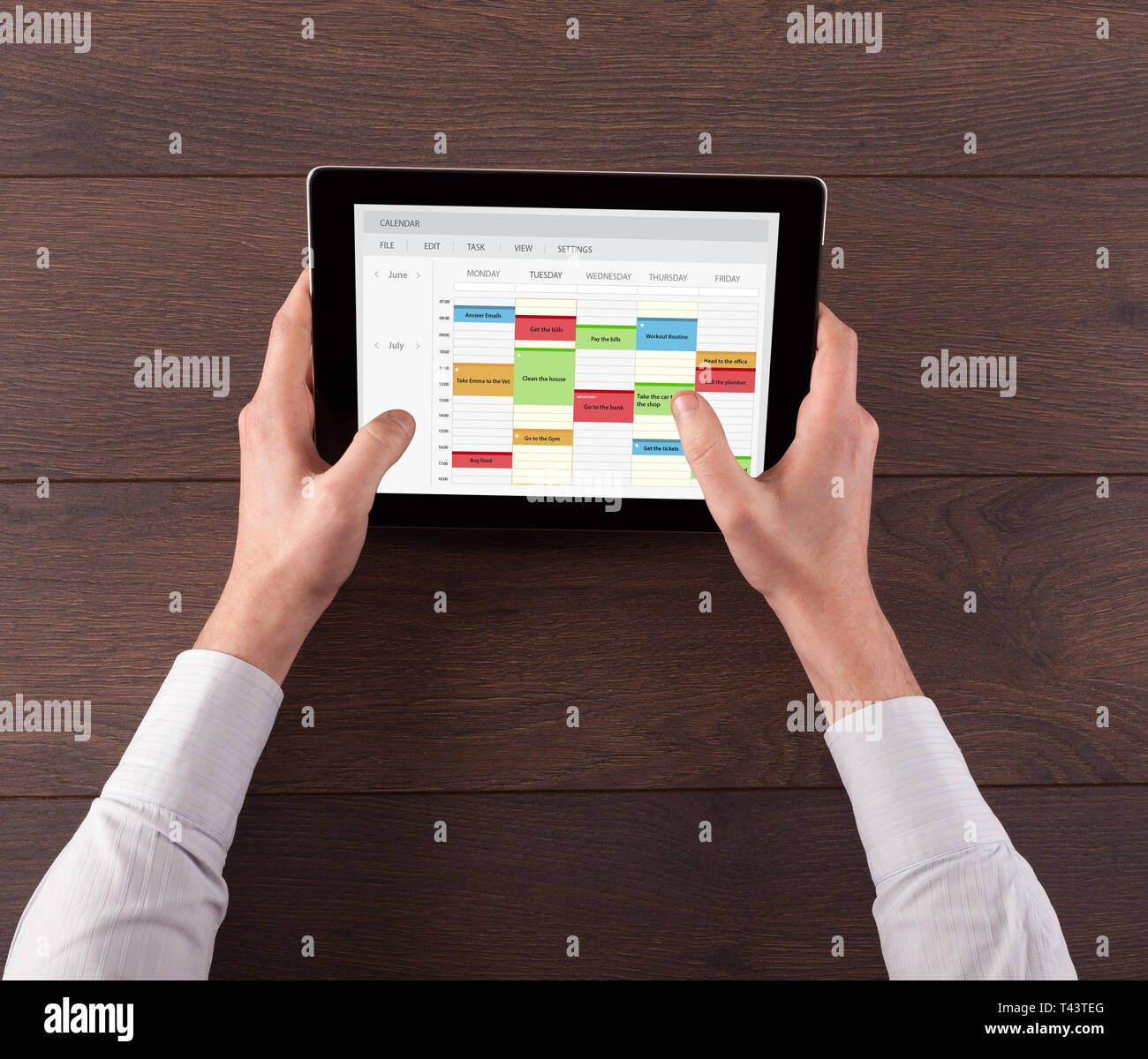 Hand holding tablet with timetable and calendar concept Stock Photo - Alamy