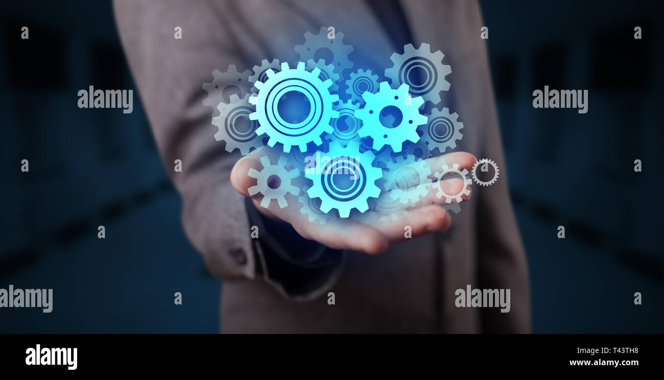 Hand holding gears in his hand concept Stock Photo - Alamy