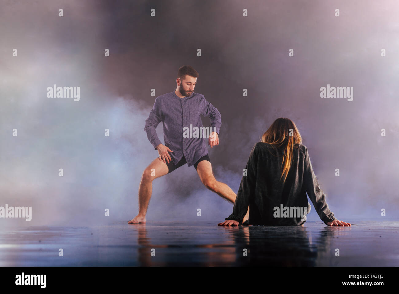 Shoeless dance couple performing multiple unique dance moves in front ...