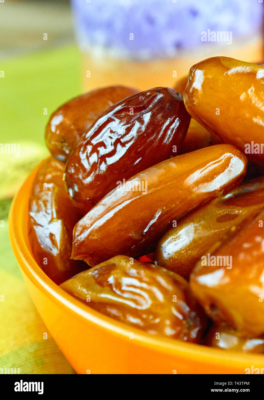 sweet algerian arabic dates fruits on an orange plate Stock Photo - Alamy