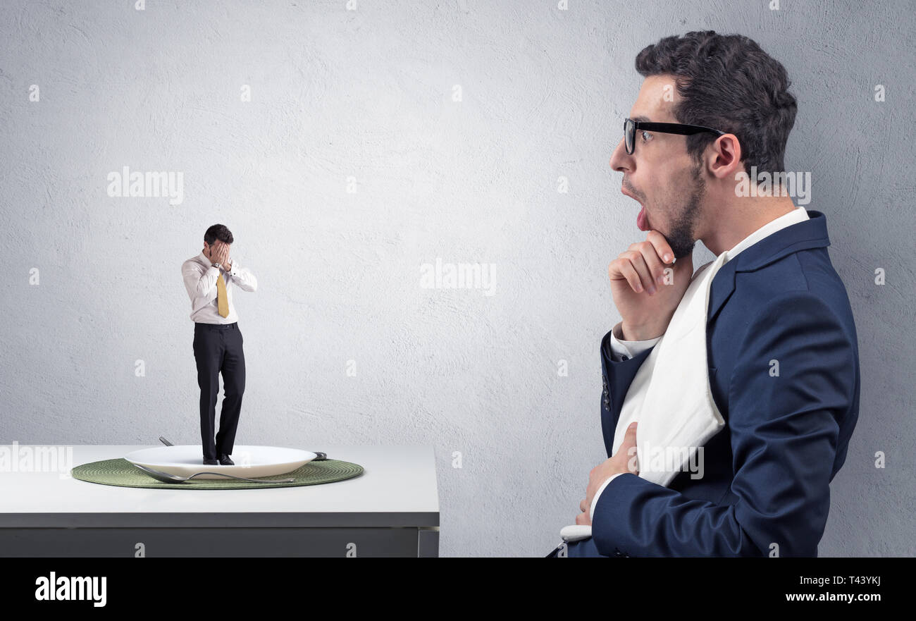Tiny scared weak businessman almost devoured by great power Stock Photo ...