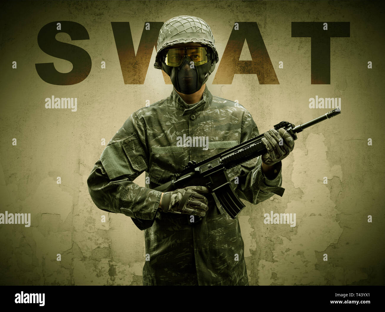 Uniformed armed soldier with damaged wall background Stock Photo - Alamy