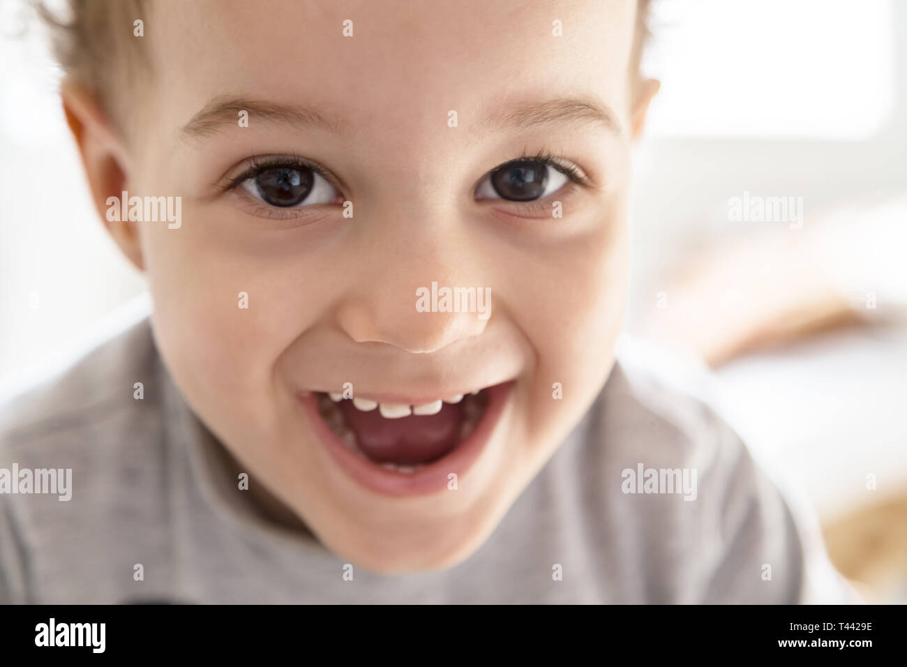 Portrait of cute adorable two years old boy smiling and looking at ...