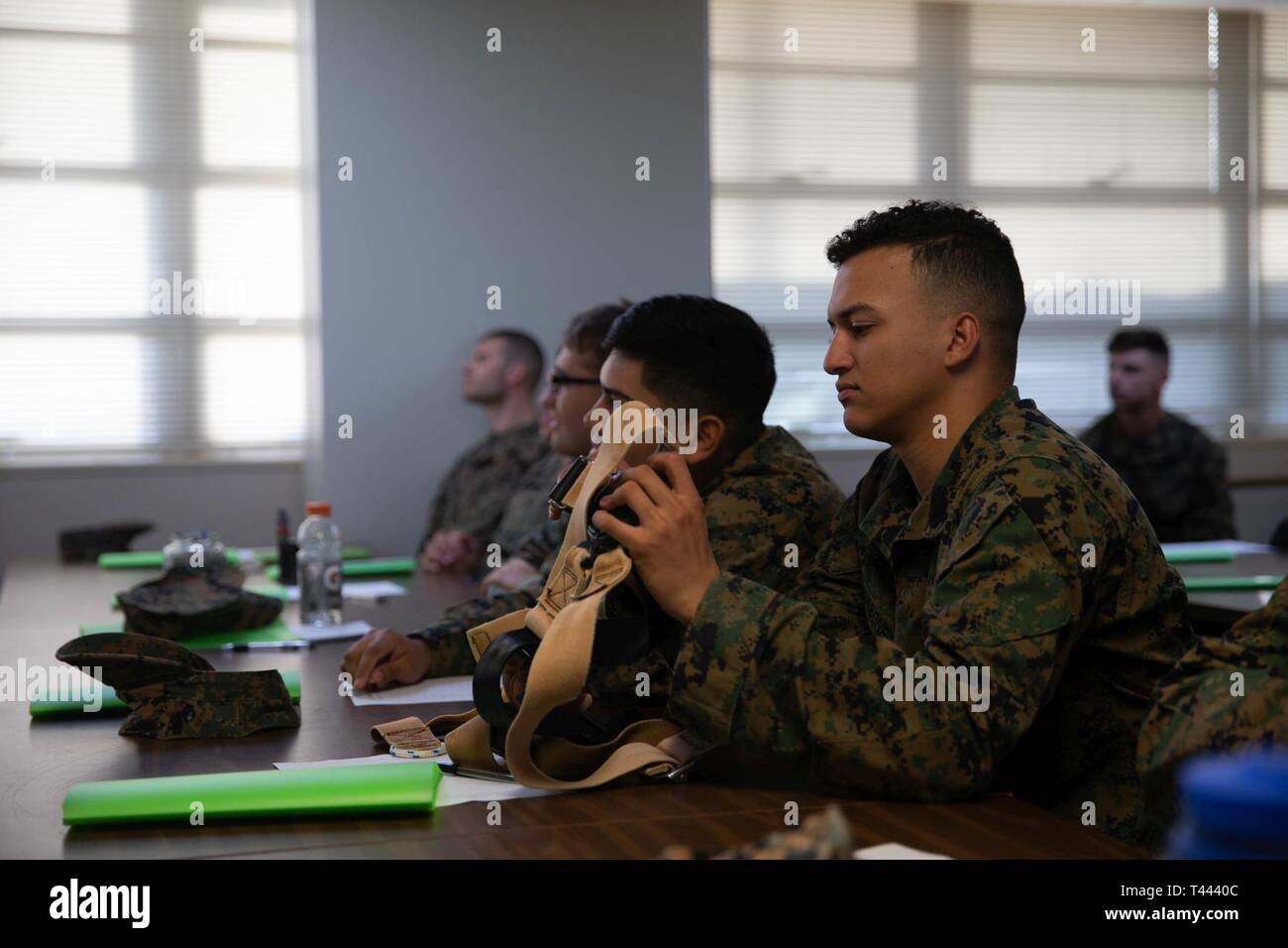 U.S. Marines with Headquarters Battalion, 3rd Marine Division, receive ...